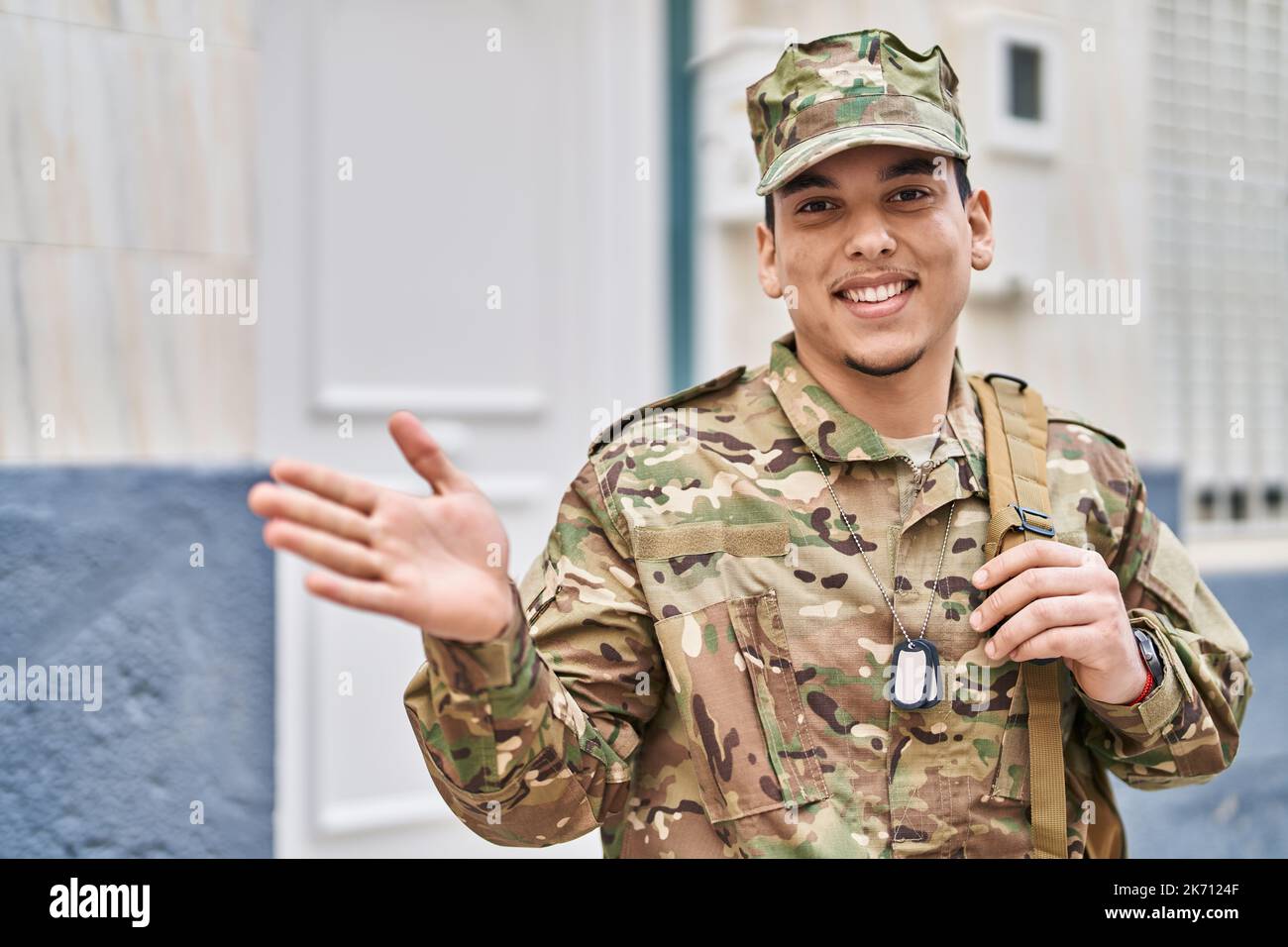 Young arab man wearing camouflage army uniform outdoors celebrating ...