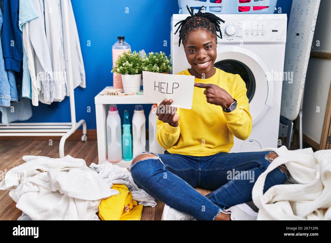 Beautiful black woman doing laundry asking for help smiling happy ...