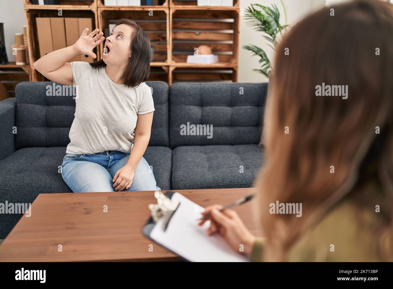 Hispanic girl with down syndrome doing therapy shouting and screaming ...