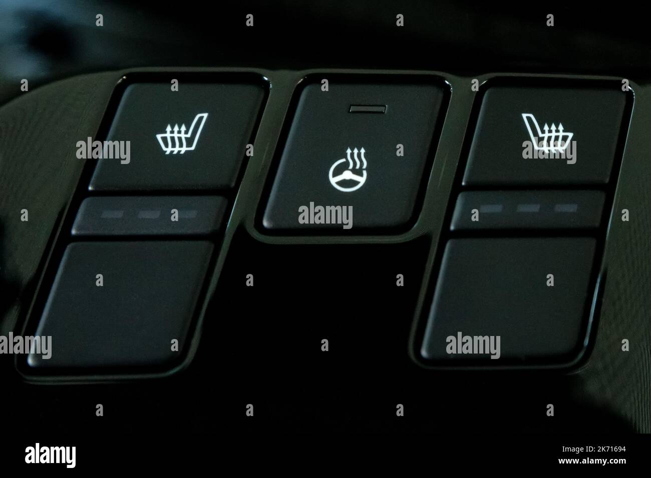 Close up black button for seat and steering wheel heating in modern car ...