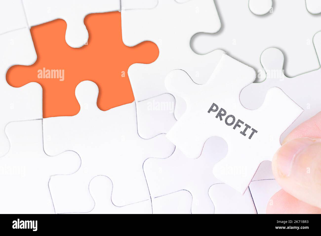 Female hand and missing puzzle with PROFIT WORD Stock Photo - Alamy