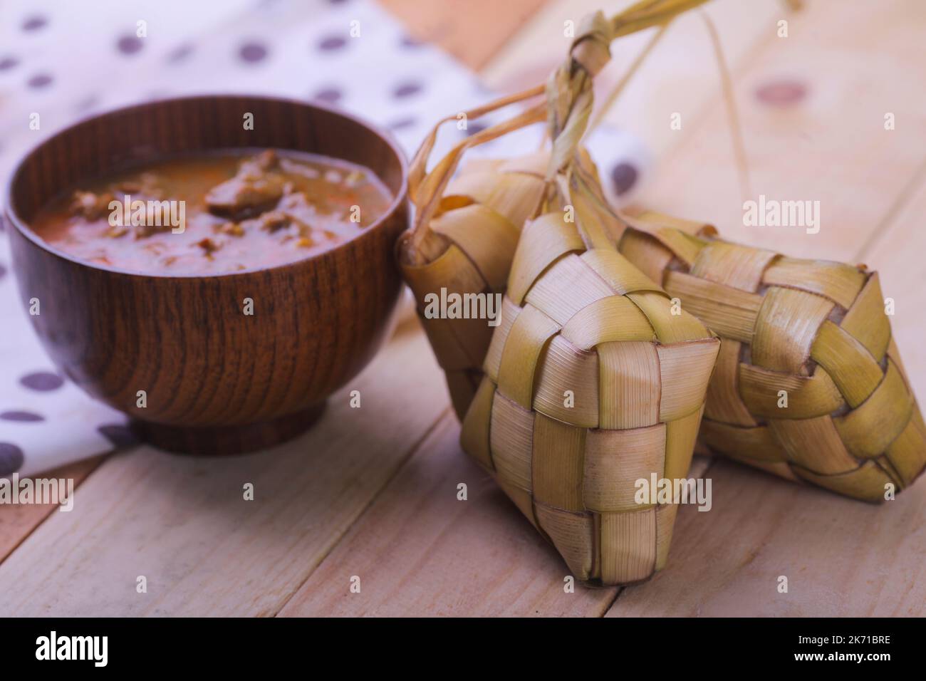 Ketupat (Rice Dumpling) and curry On wooden Background. Ketupat is a ...