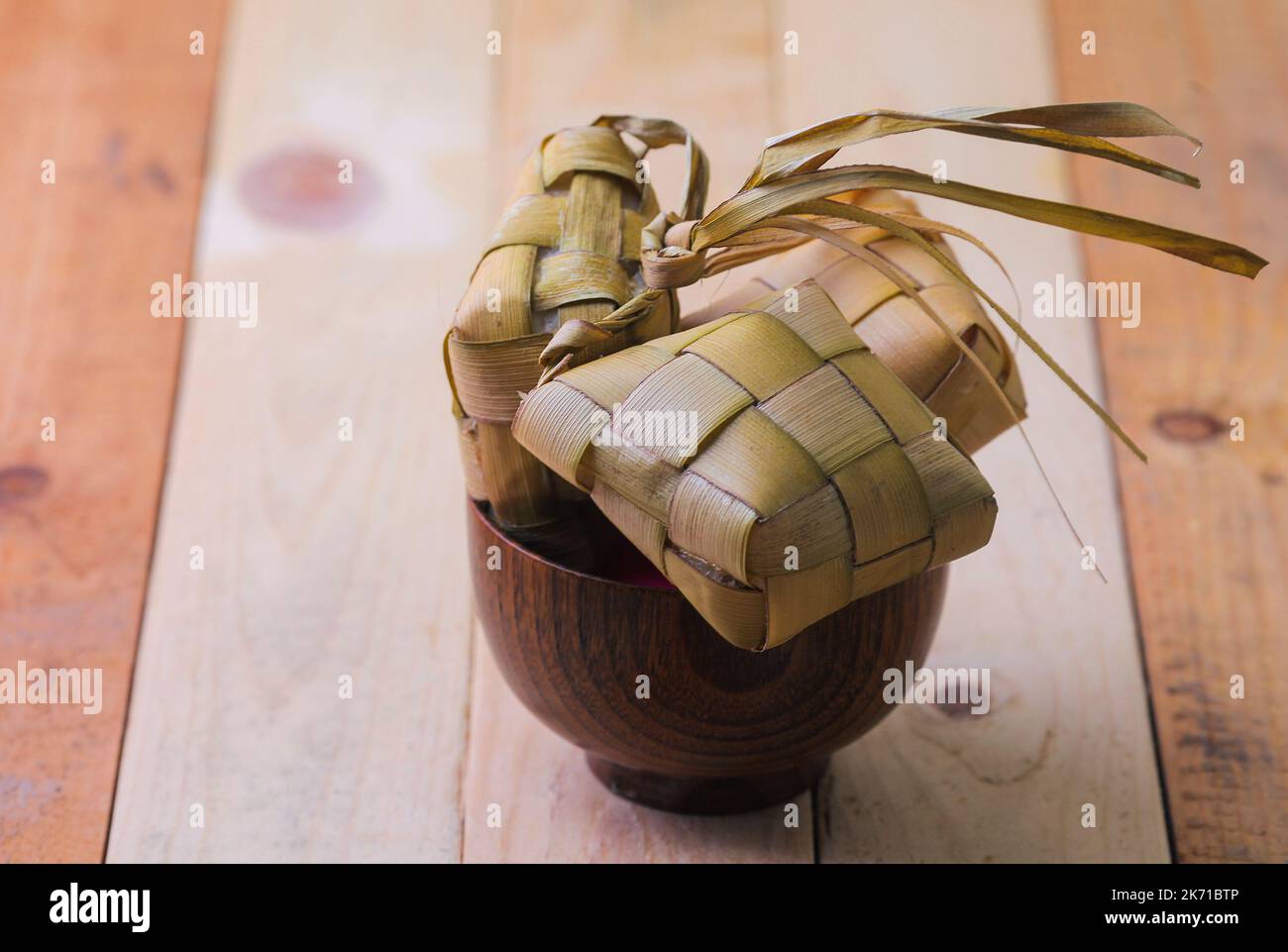 Ketupat (Rice Dumpling) and curry On wooden Background. Ketupat is a ...