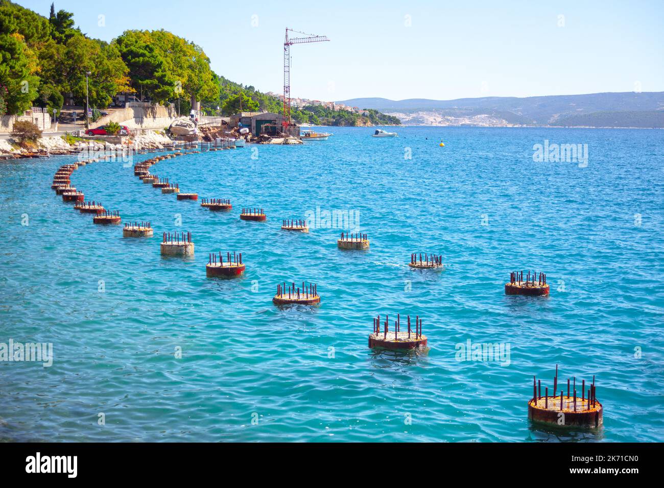 Unfinished bridge columns in the water . Concrete columns with rebar in ...