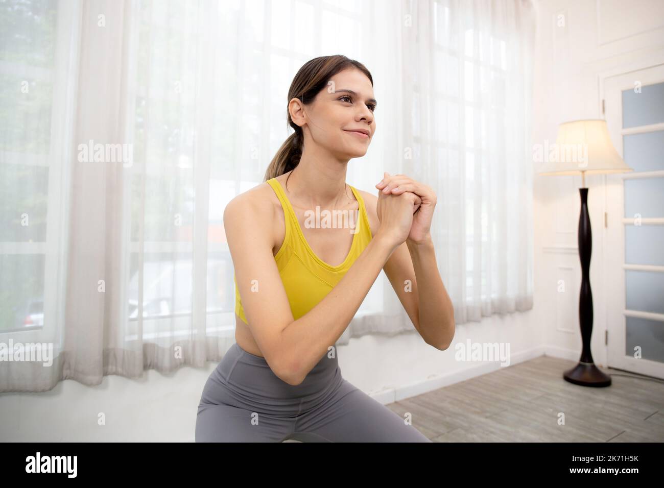 Beautiful young caucasian woman practicing workout stretching squat for ...