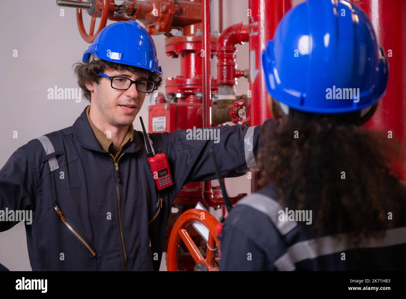 Young woman and man engineer check and examining pipeline and ...