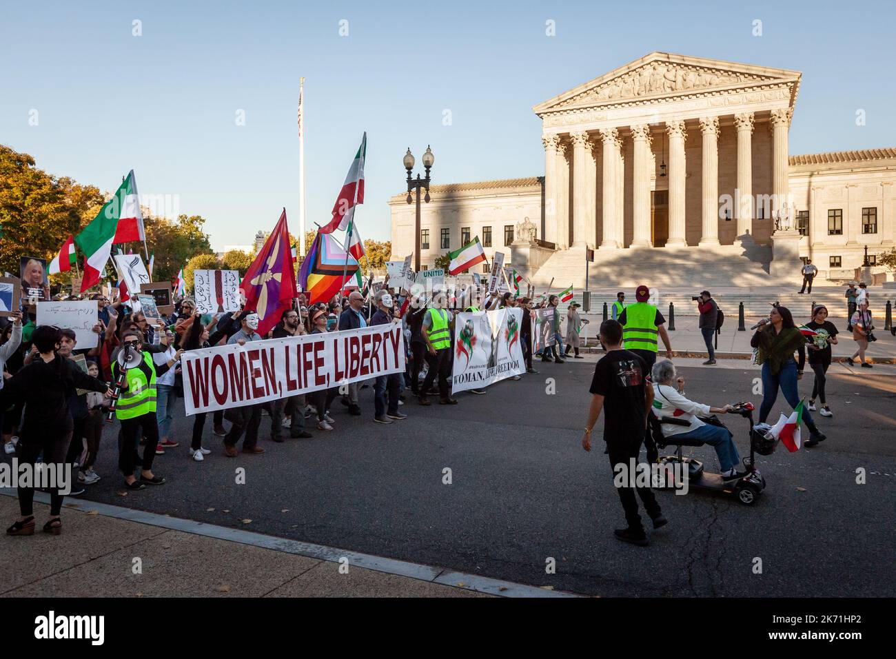 Washington, United States. 15th Oct, 2022. Protesters march past the ...