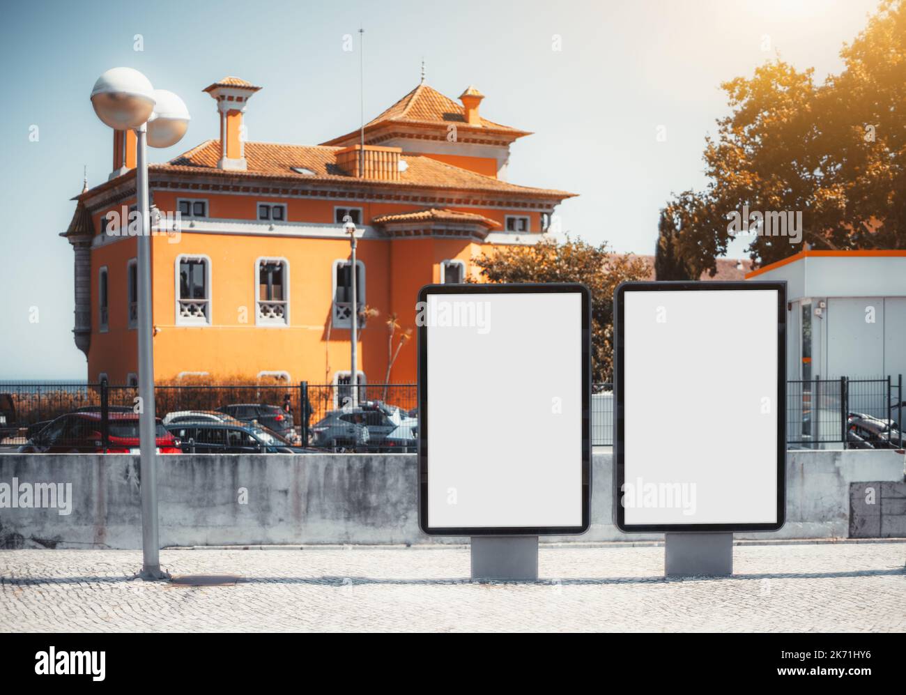 Two empty mock-ups of street advertising billboards on the pavement ...