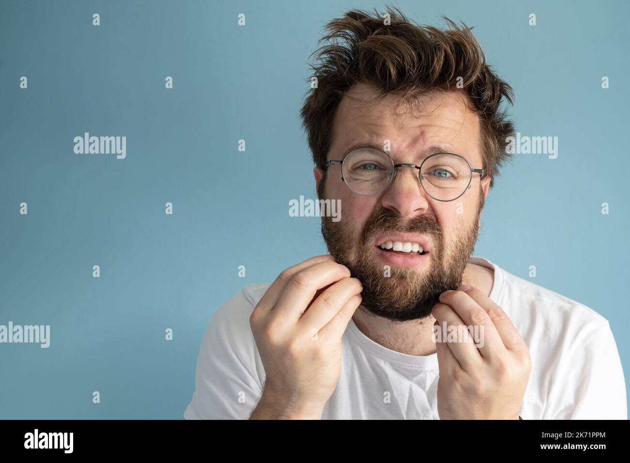 Man woke up after a party, he touches his beard and is puzzled by his ...