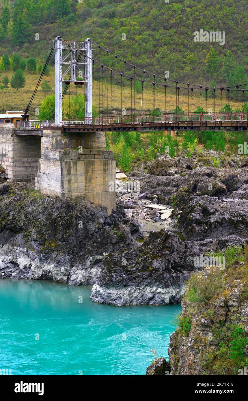 Orokto bridge on the Katuni River. A suspension bridge on the rocky ...