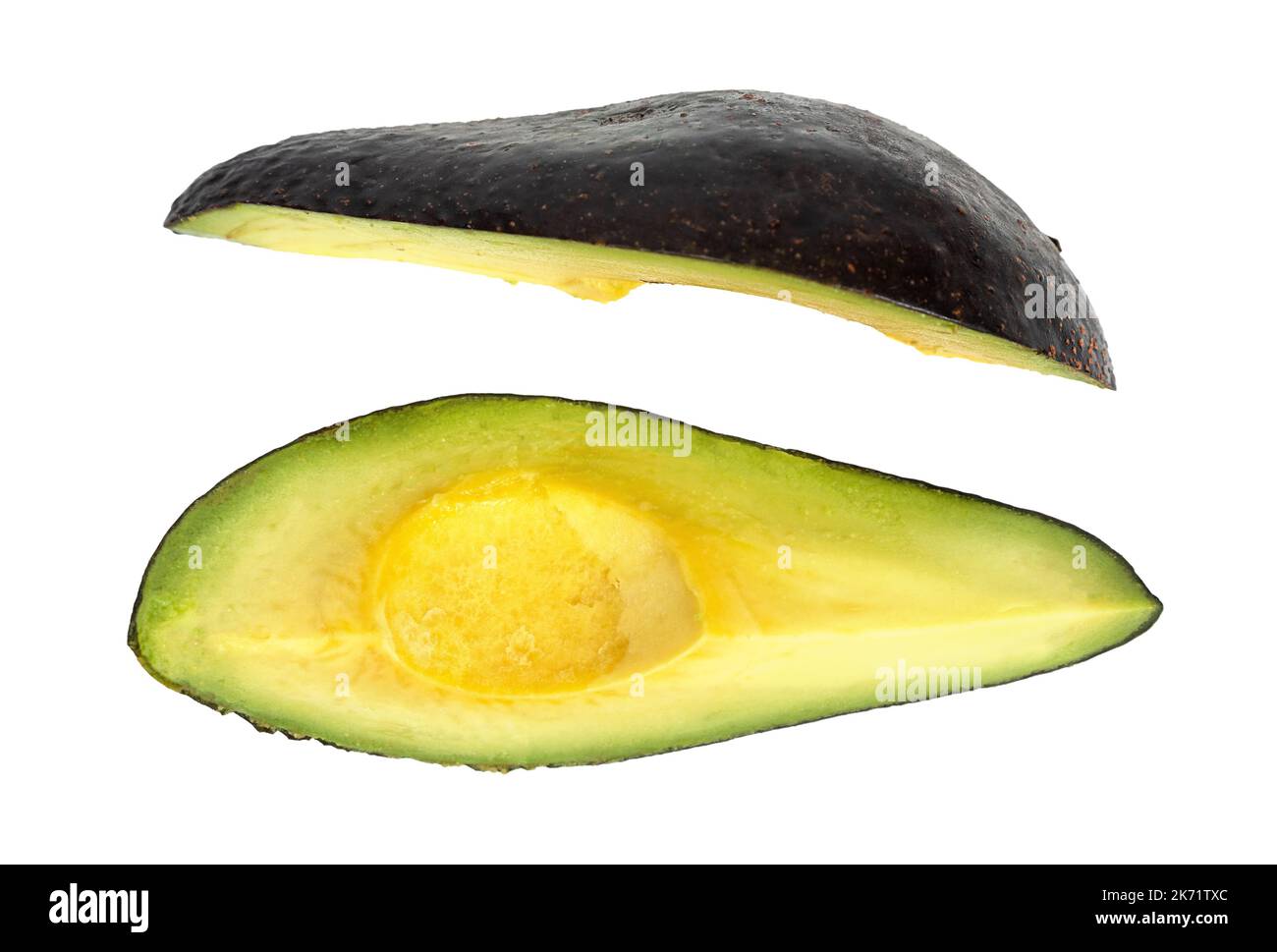 Green avocado two slices isolated on white background Stock Photo - Alamy