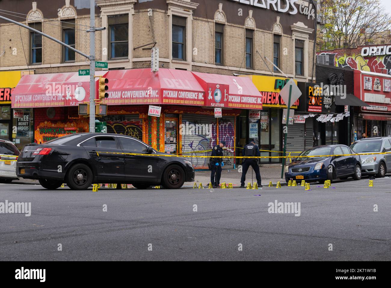 Members of the Crime Scene Unit investigate a police shooting with ...