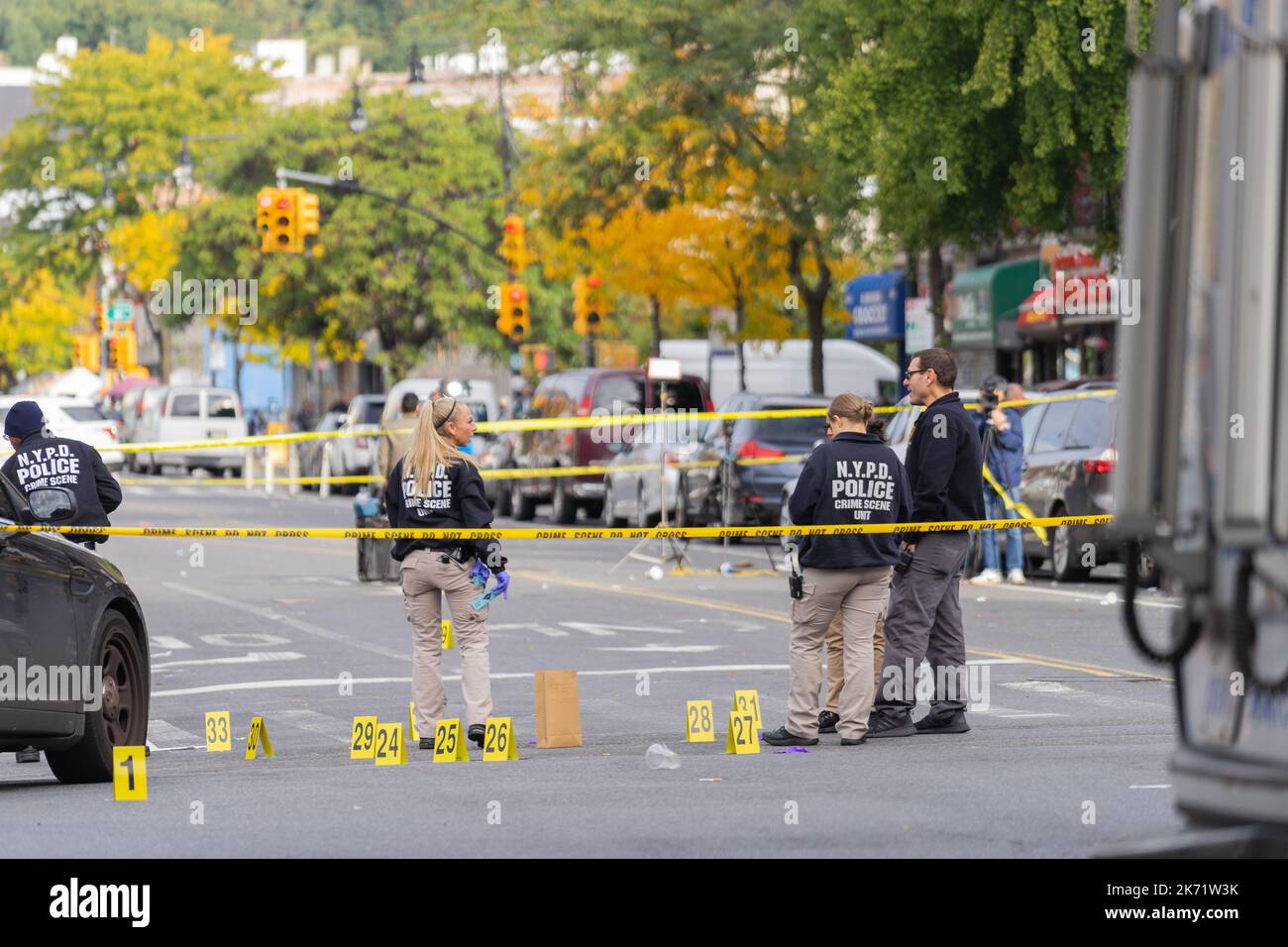 Members of the Crime Scene Unit investigate a police shooting with ...