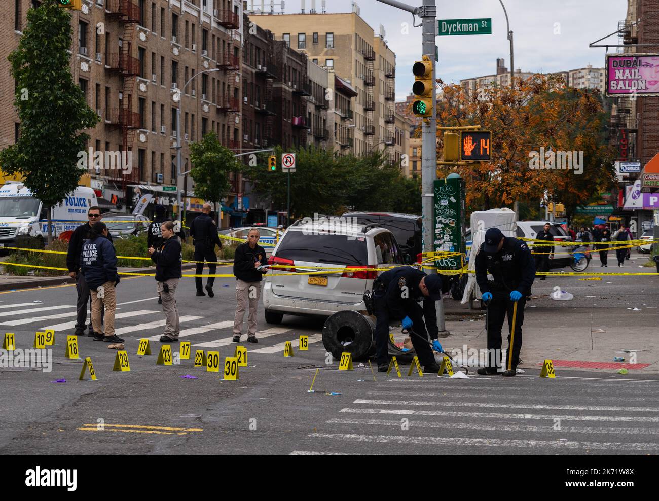 Members of the Crime Scene Unit investigate a police shooting with ...