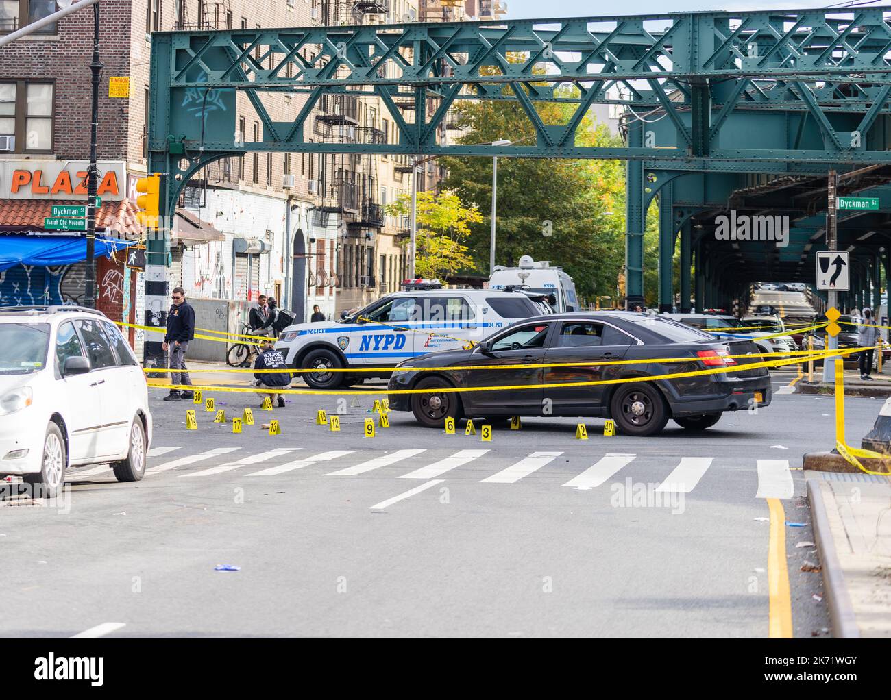 Members of the Crime Scene Unit investigate a police shooting with ...