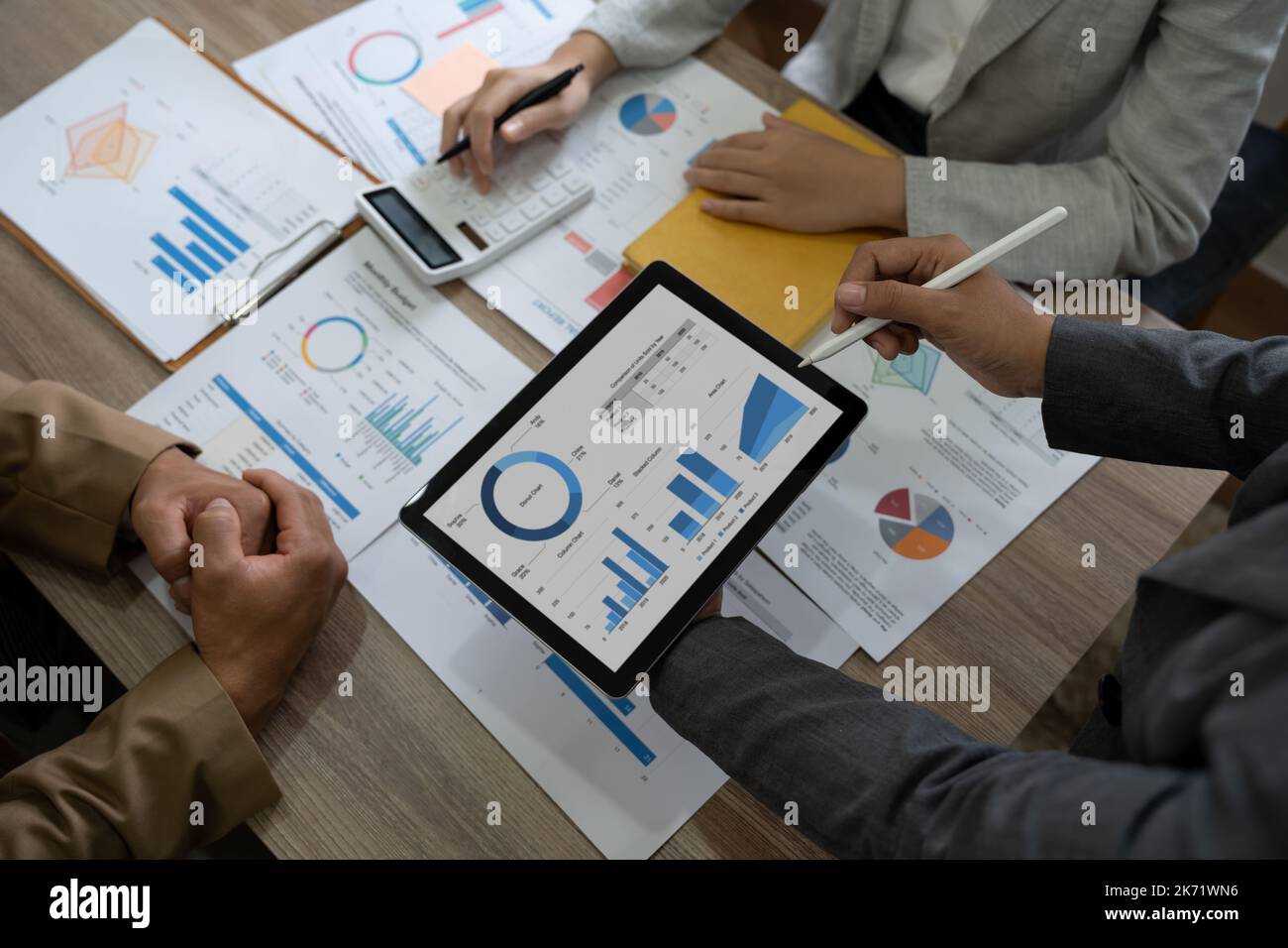 Top view of business colleagues in modern office analyzing income ...