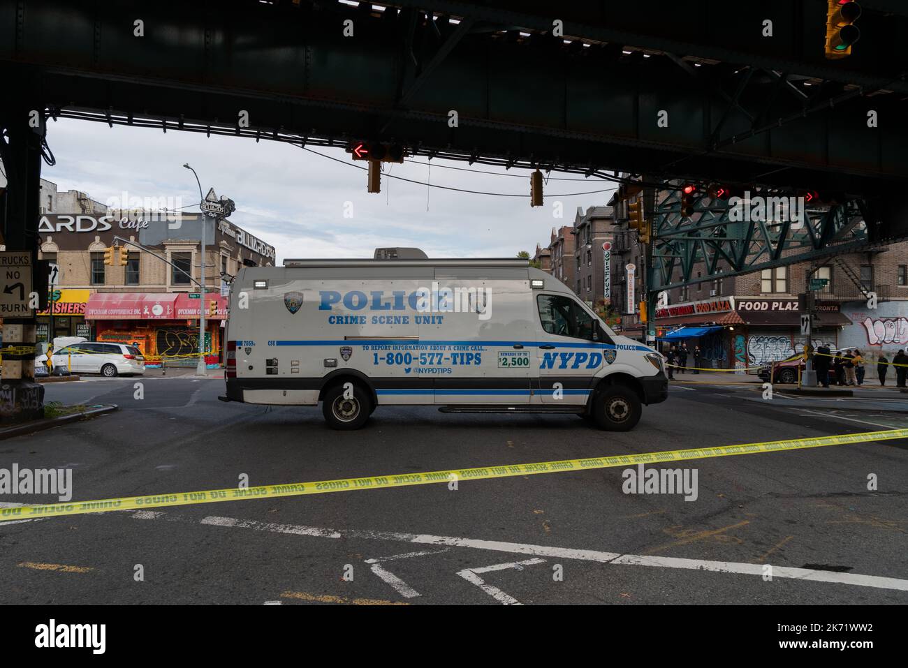 Members of the Crime Scene Unit investigate a police shooting with ...