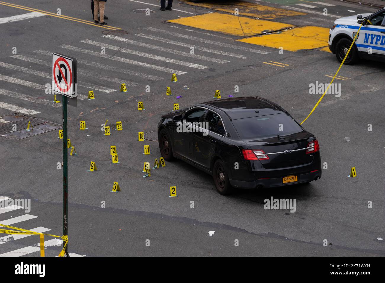 Members of the Crime Scene Unit investigate a police shooting with ...