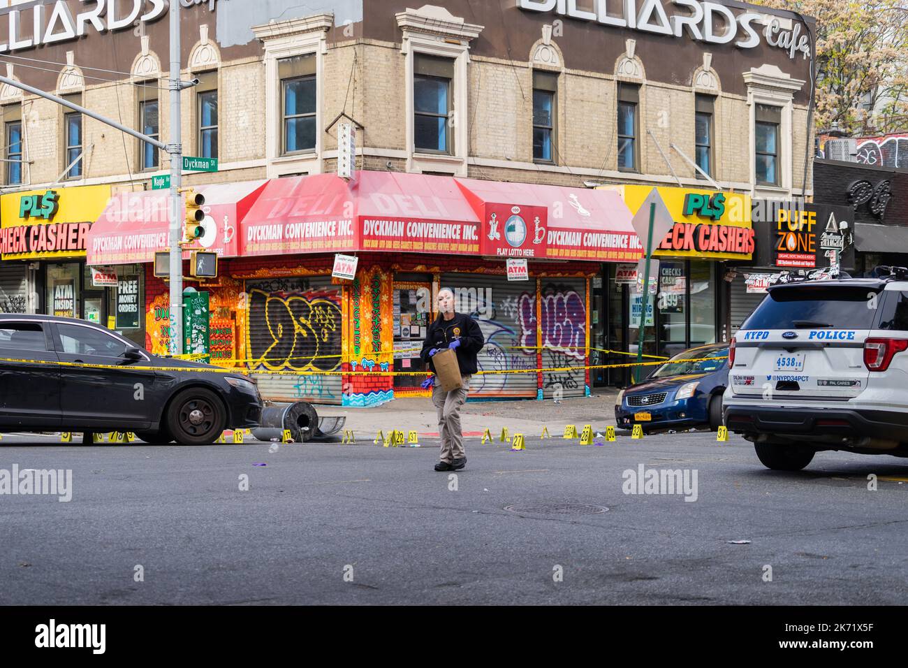 Members of the Crime Scene Unit investigate a police shooting with ...