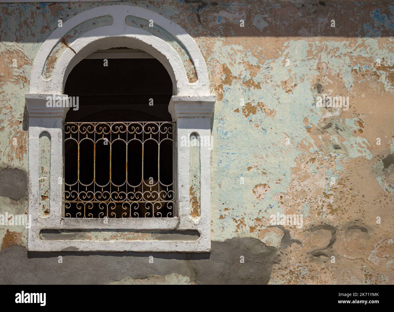Old wall with a window and a grille. Construction concept without ...