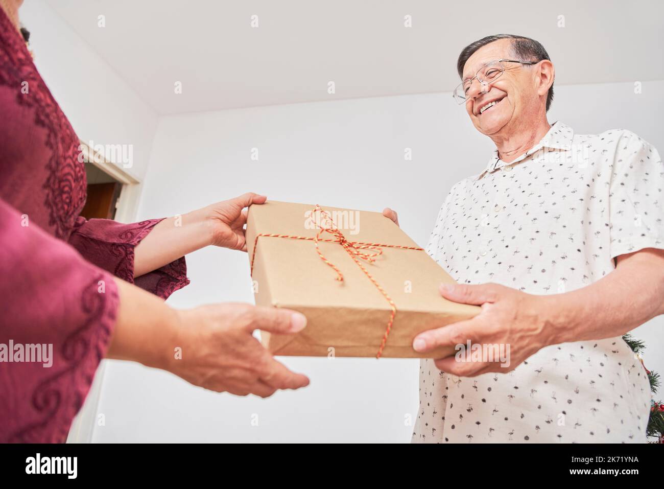 Senior latin couple happily spending the holidays together at home, the ...