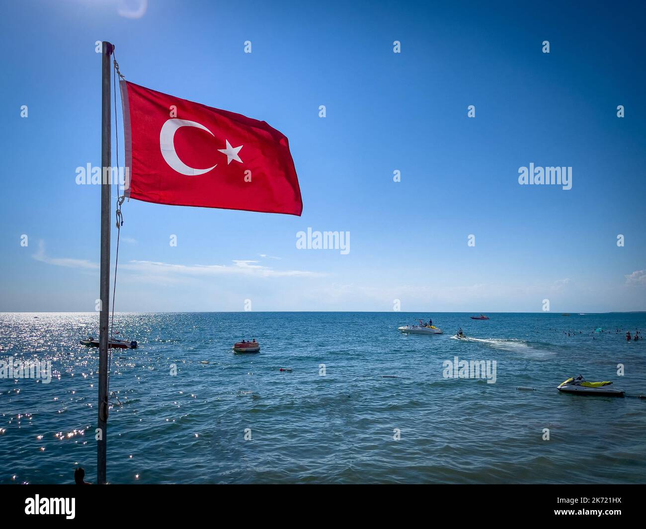 on the sunny beach in Turkey flies the red flag of Turkey Stock Photo ...