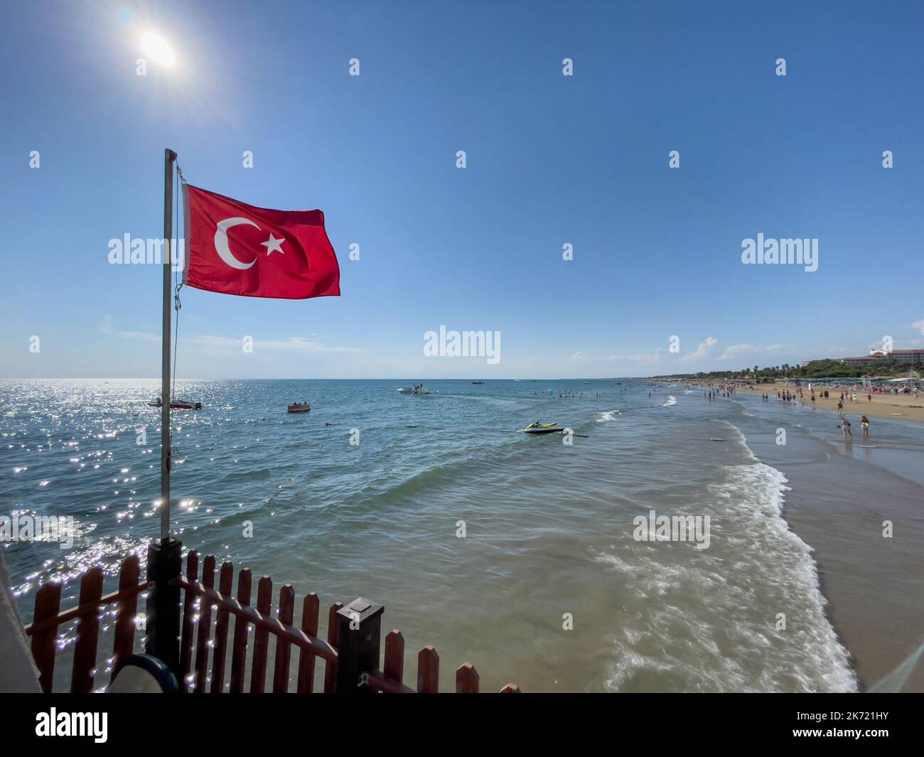 on the sunny beach in Turkey flies the red flag of Turkey Stock Photo ...