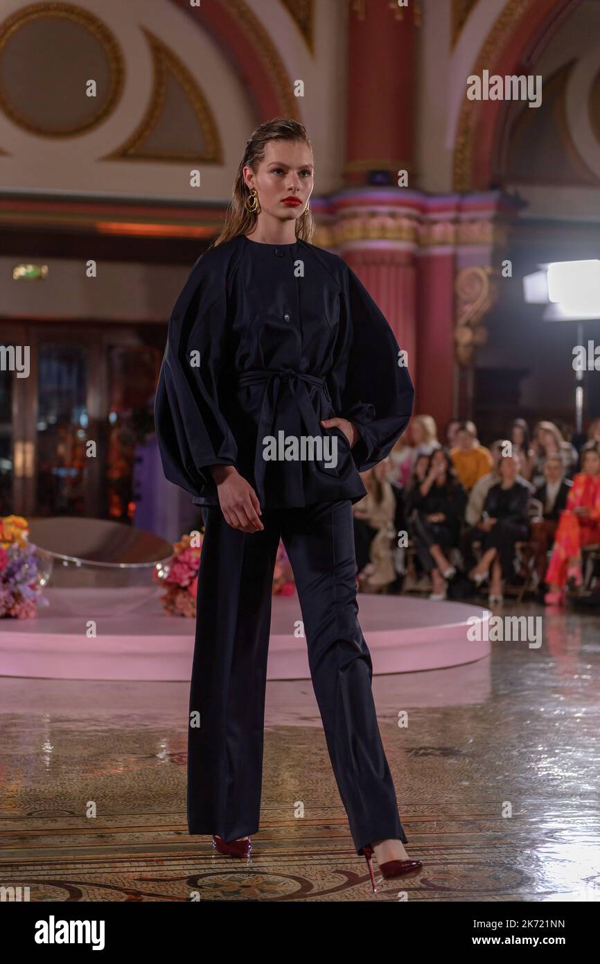 A model wearing an outfit by designer Martin Grant walks the runway ...