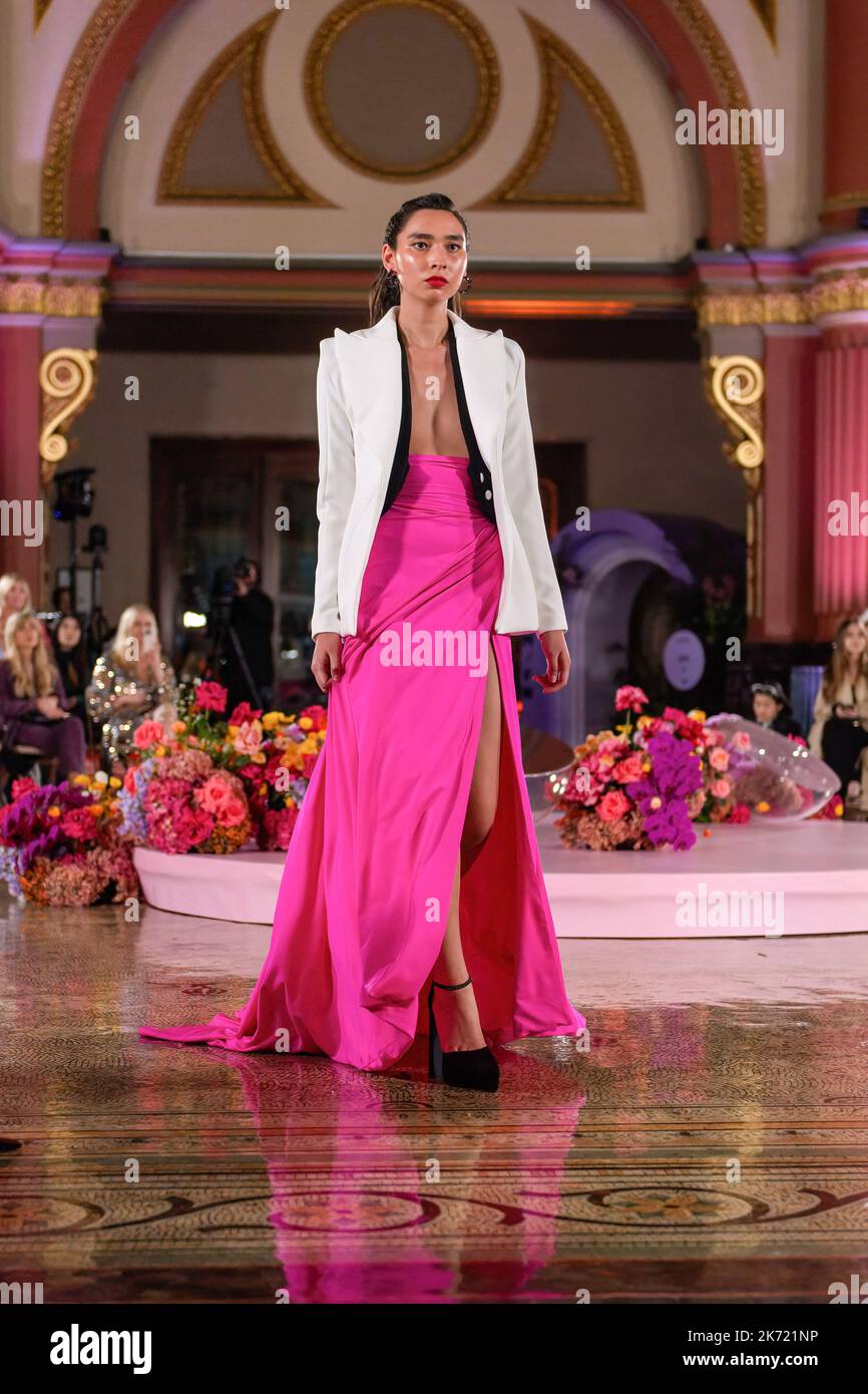 A model wearing an outfit by designer Mariam Seddiq walks the runway ...