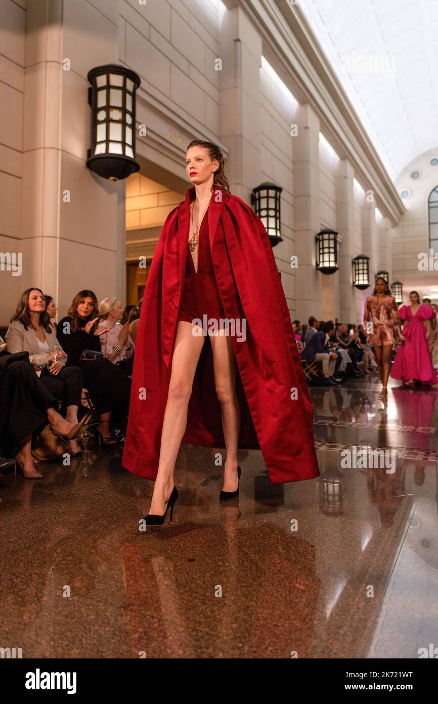 A model wearing an outfit by designer Martin Grant walks the runway ...