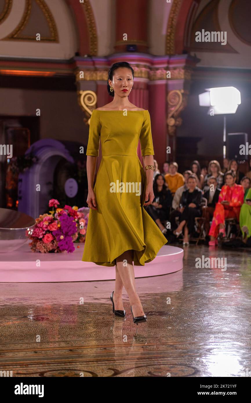 A model wearing an outfit by designer Martin Grant walks the runway ...
