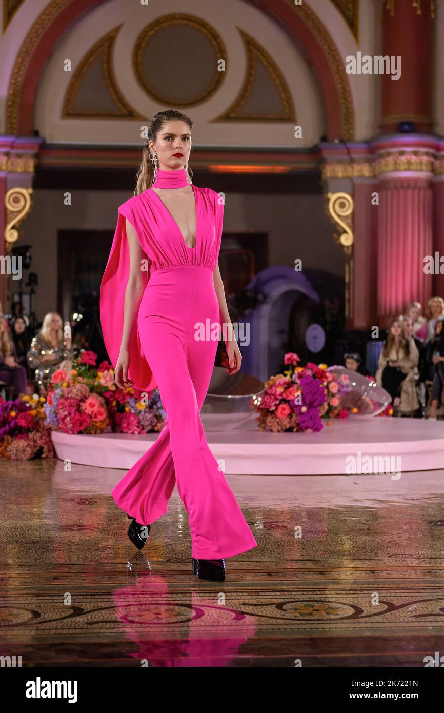A model wearing an outfit by designer Mariam Seddiq walks the runway ...