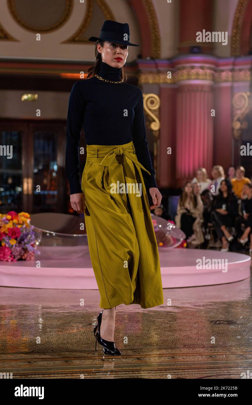 A model wearing an outfit by designer Martin Grant walks the runway ...