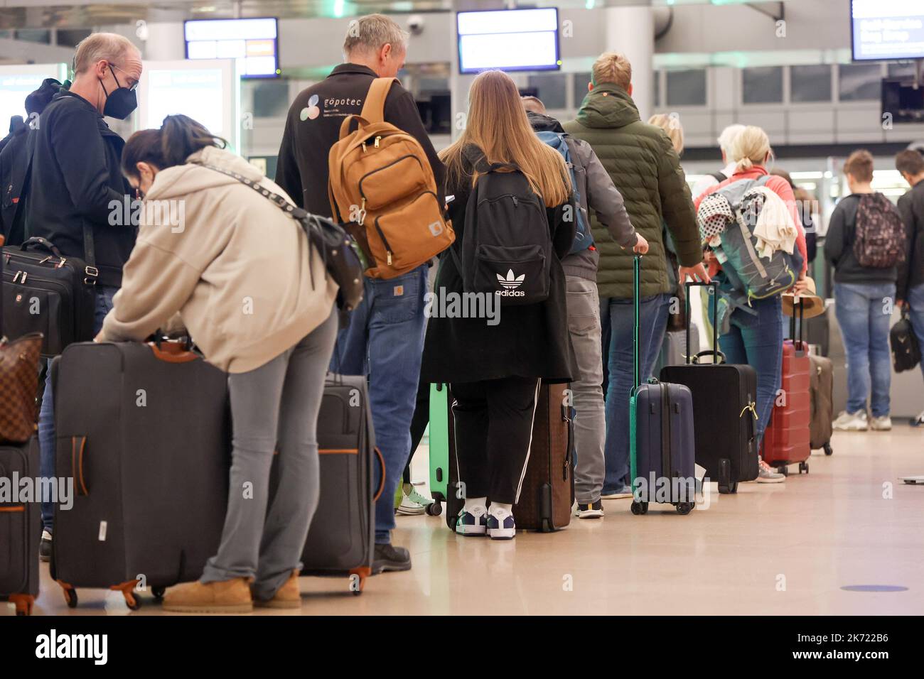 Hamburg, Germany. 17th Oct, 2022. Travelers line up at a check-in ...