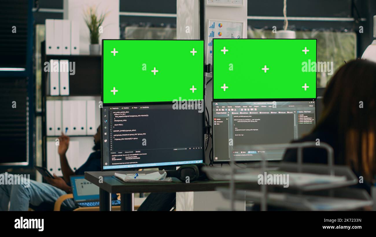 Database Developer Analyzing Greenscreen Display On Multiple Screens Working With Server Code