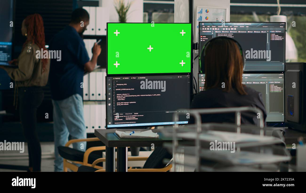 Software Developer Analyzing Greenscreen And Server Code On Multiple Monitors In Busy Ai 