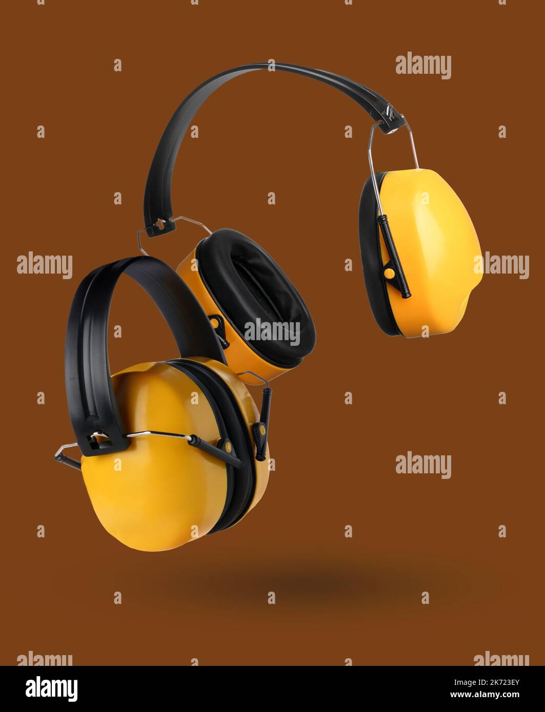 Modern hearing protectors on brown background Stock Photo - Alamy