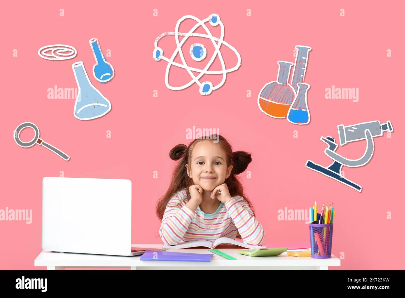 Little girl doing homework at table on pink background Stock Photo - Alamy
