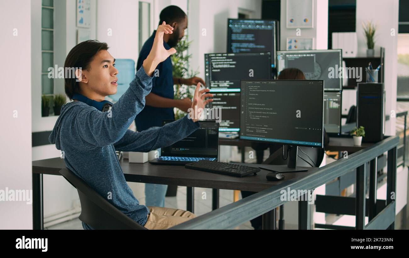 Asian Web Developer Working With Hologram And Augmented Reality To