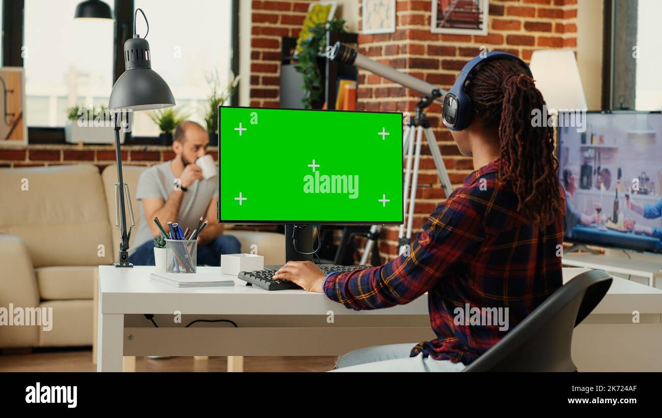 African american person working with greenscreen and listening to music ...