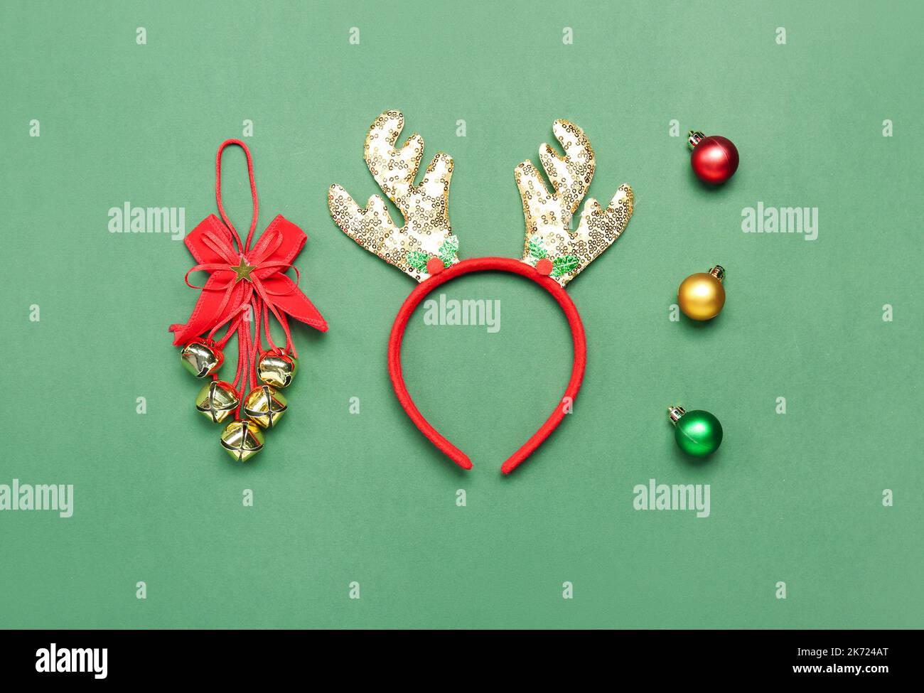 Christmas reindeer horns with bells and balls on green background Stock ...