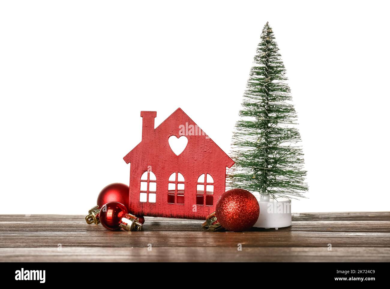 House figure with Christmas decor on table against white background ...