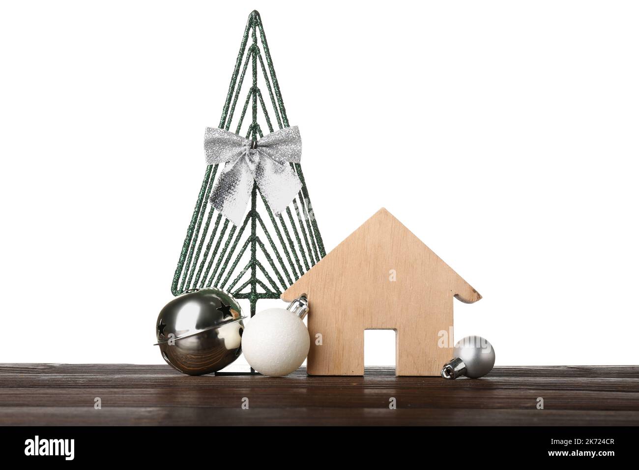 House figure with Christmas decor on table against white background ...