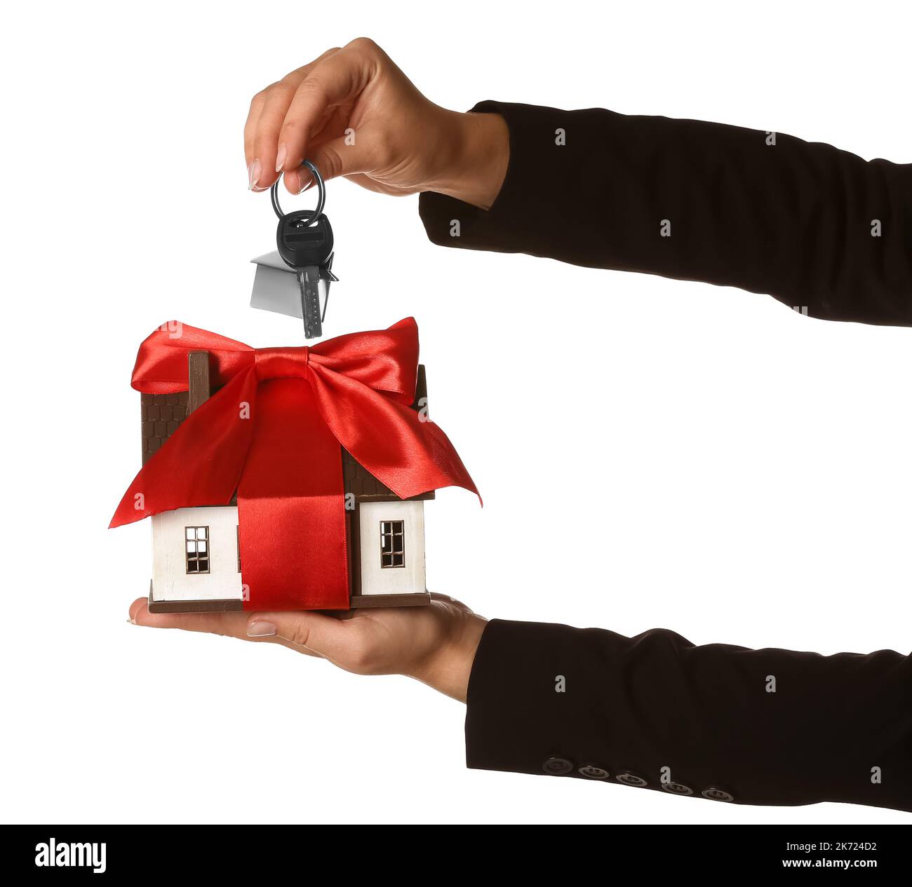 Real estate agent with house model and key on white background Stock ...
