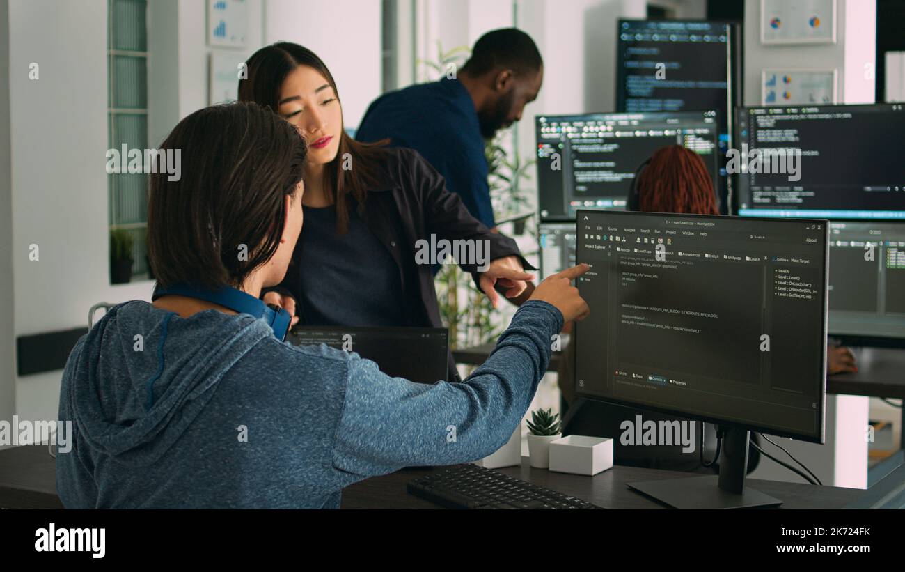 Asian database developers analyzing compiling code on multiple screens ... Asian database developers analyzing compiling code on multiple screens ...