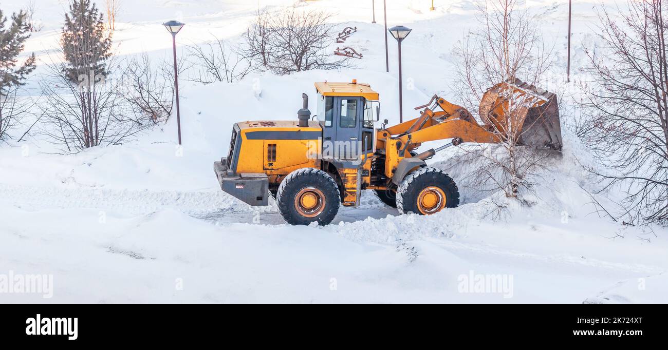 Snow clearing. Tractor clears the way after heavy snowfall Stock Photo ...