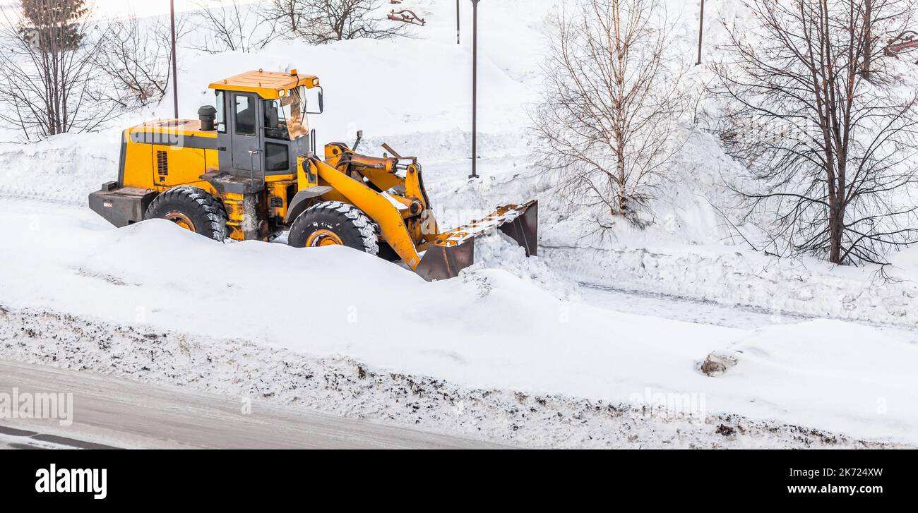 Snow clearing. Tractor clears the way after heavy snowfall Stock Photo ...