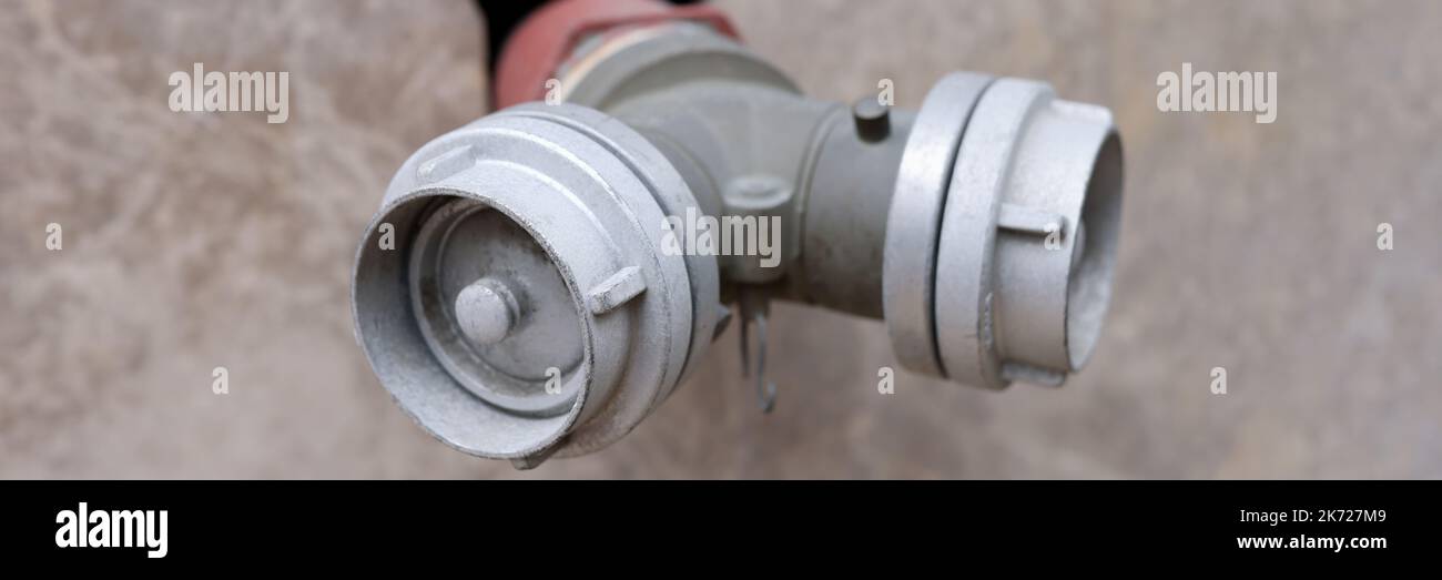 Double fire hydrant near the city wall closeup Stock Photo - Alamy