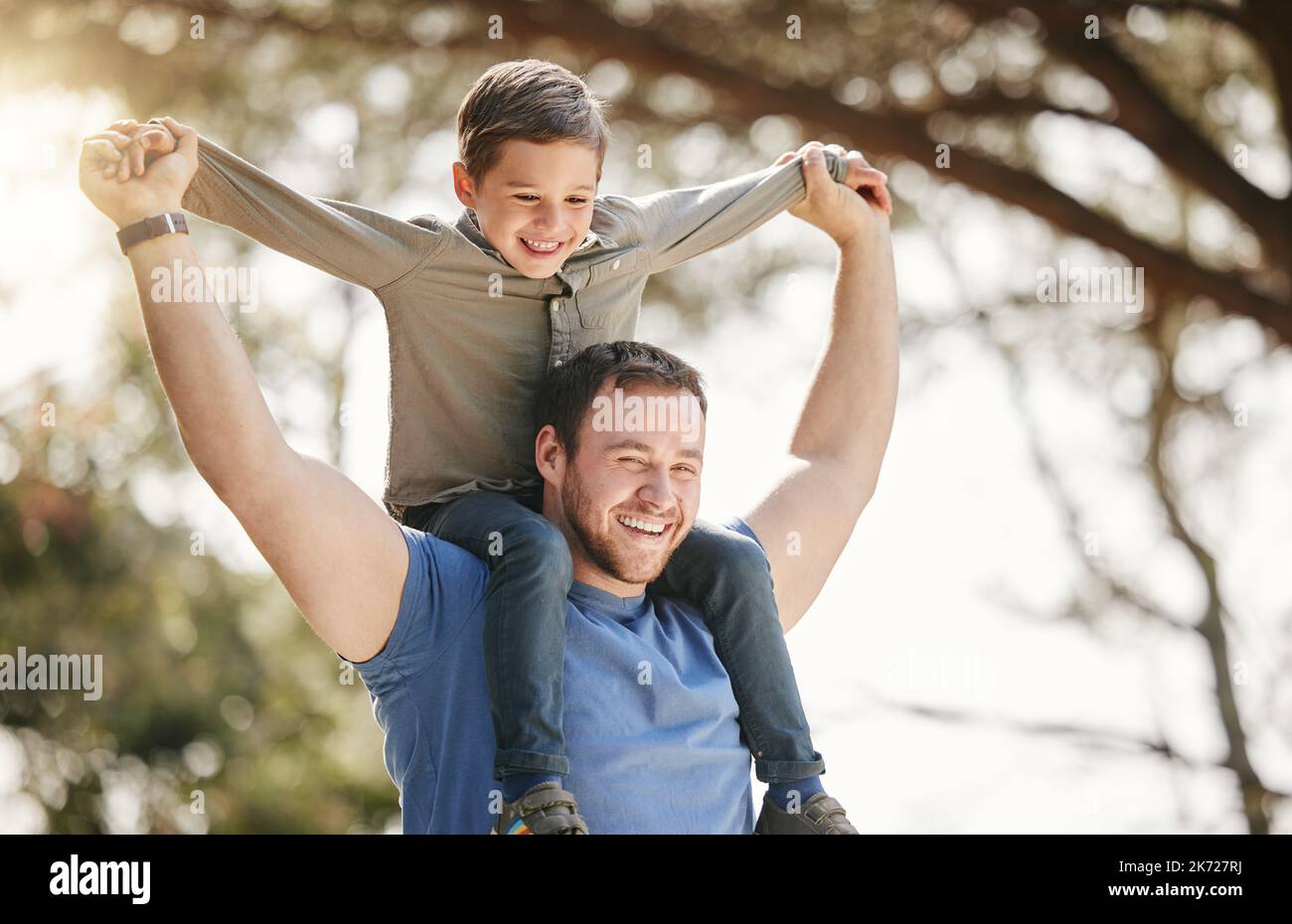 Happy caucasian father and son having fun and playing together outside ...
