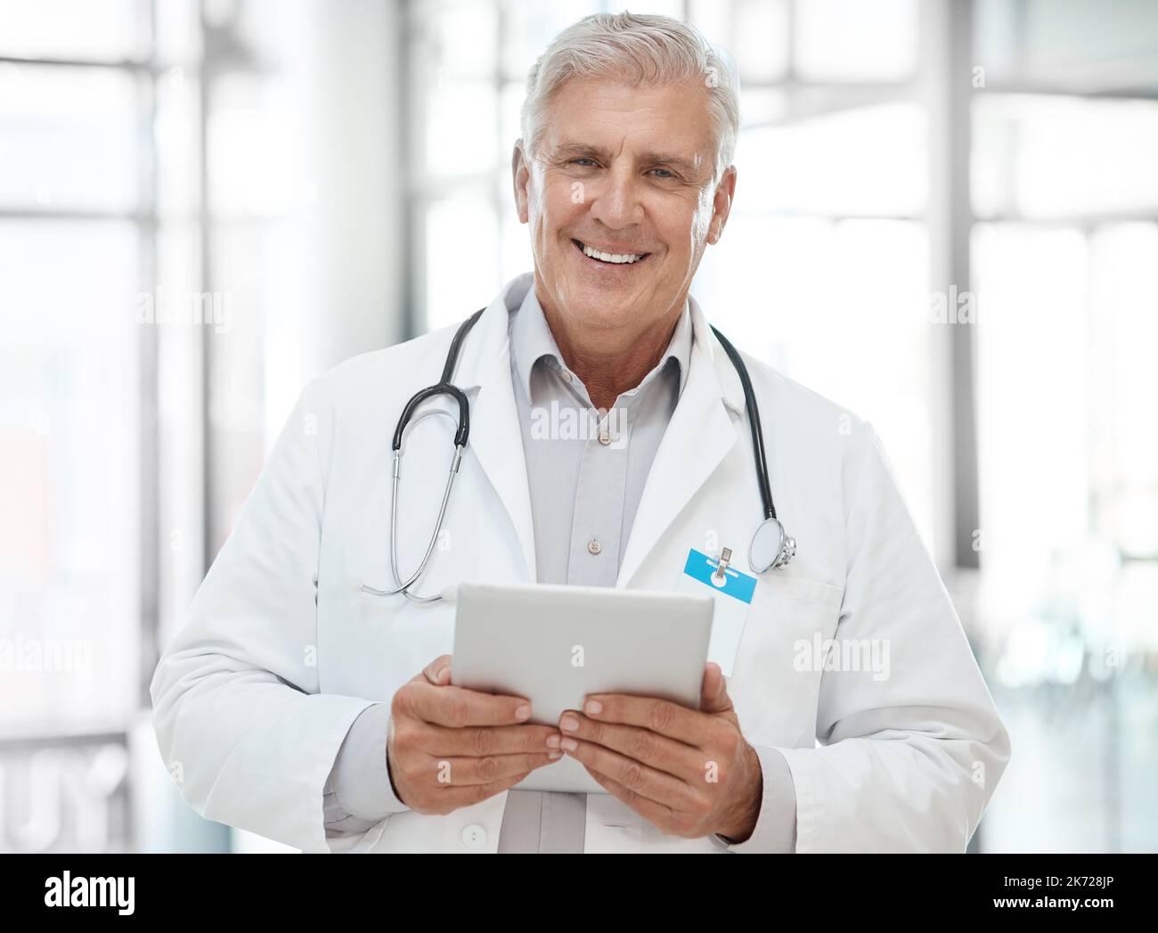 Study to save lives. a doctor using a tablet in a hospital Stock Photo ...